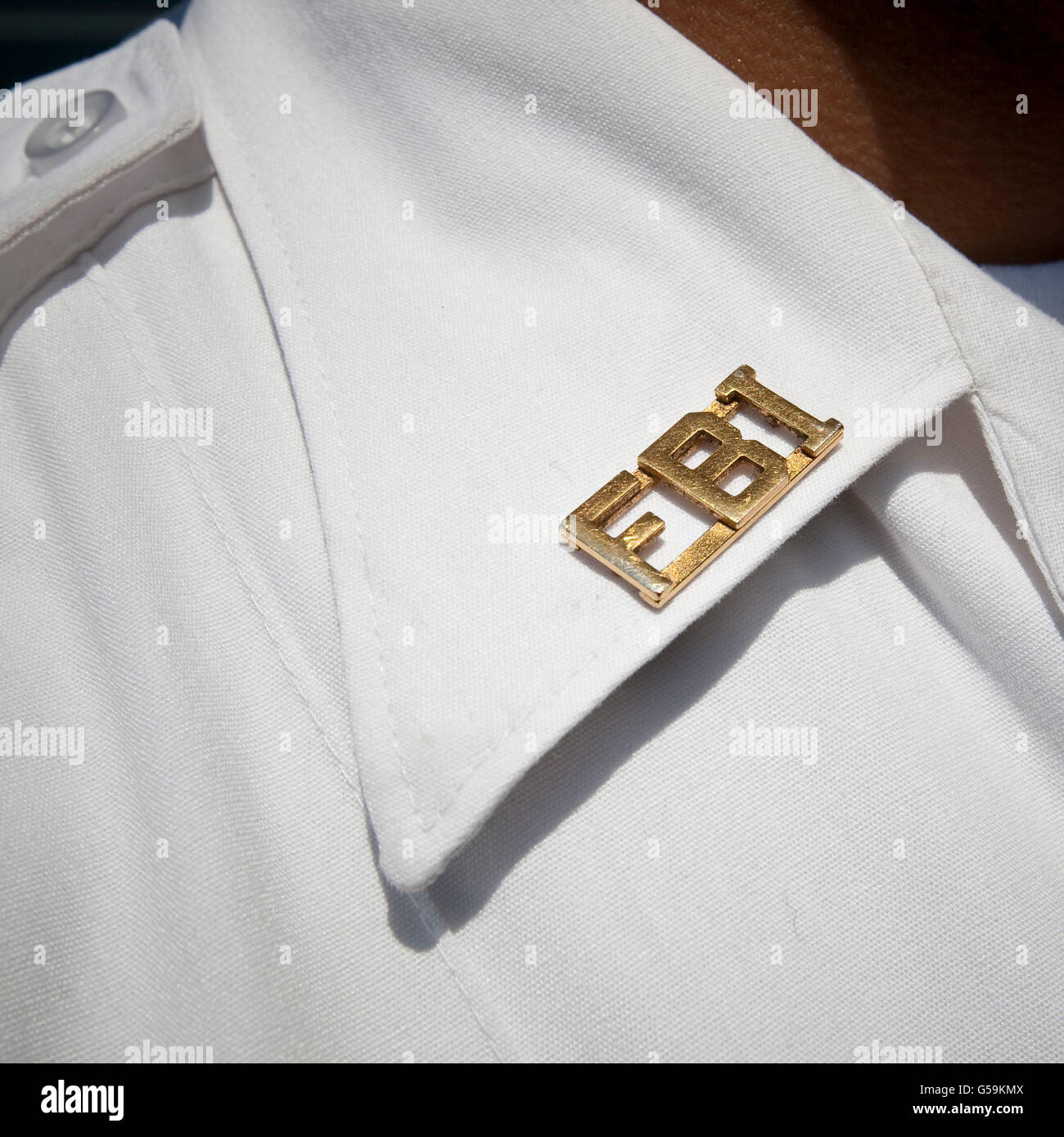 View of an FBI Police officer's FBI pin on his white shirt at the FBI ...