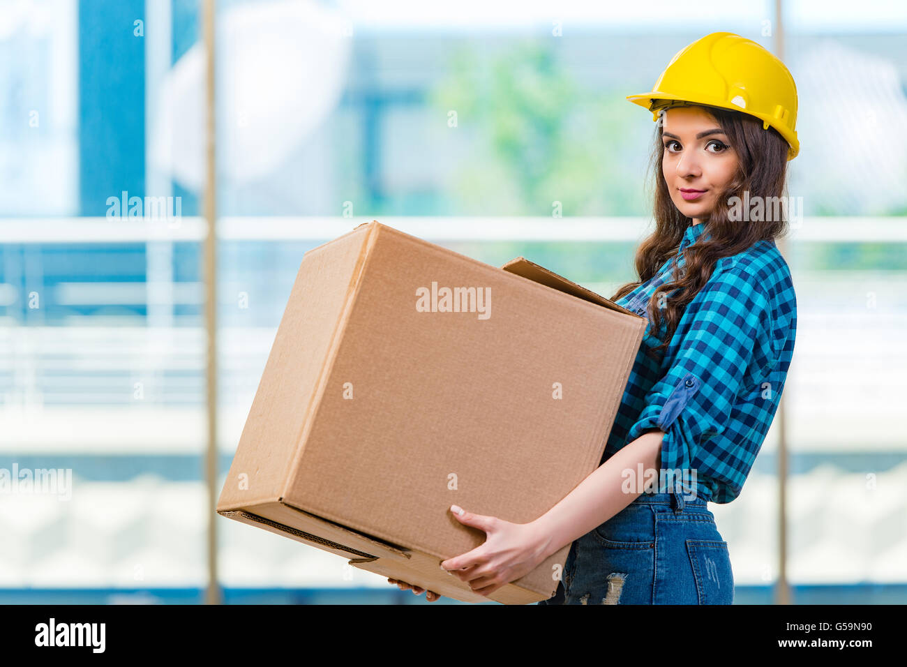Nice young woman carrying box Stock Photo - Alamy