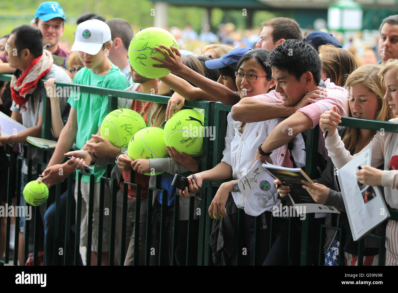 Eager fans wait for their giant tennis balls to be signed Stock Photo ...