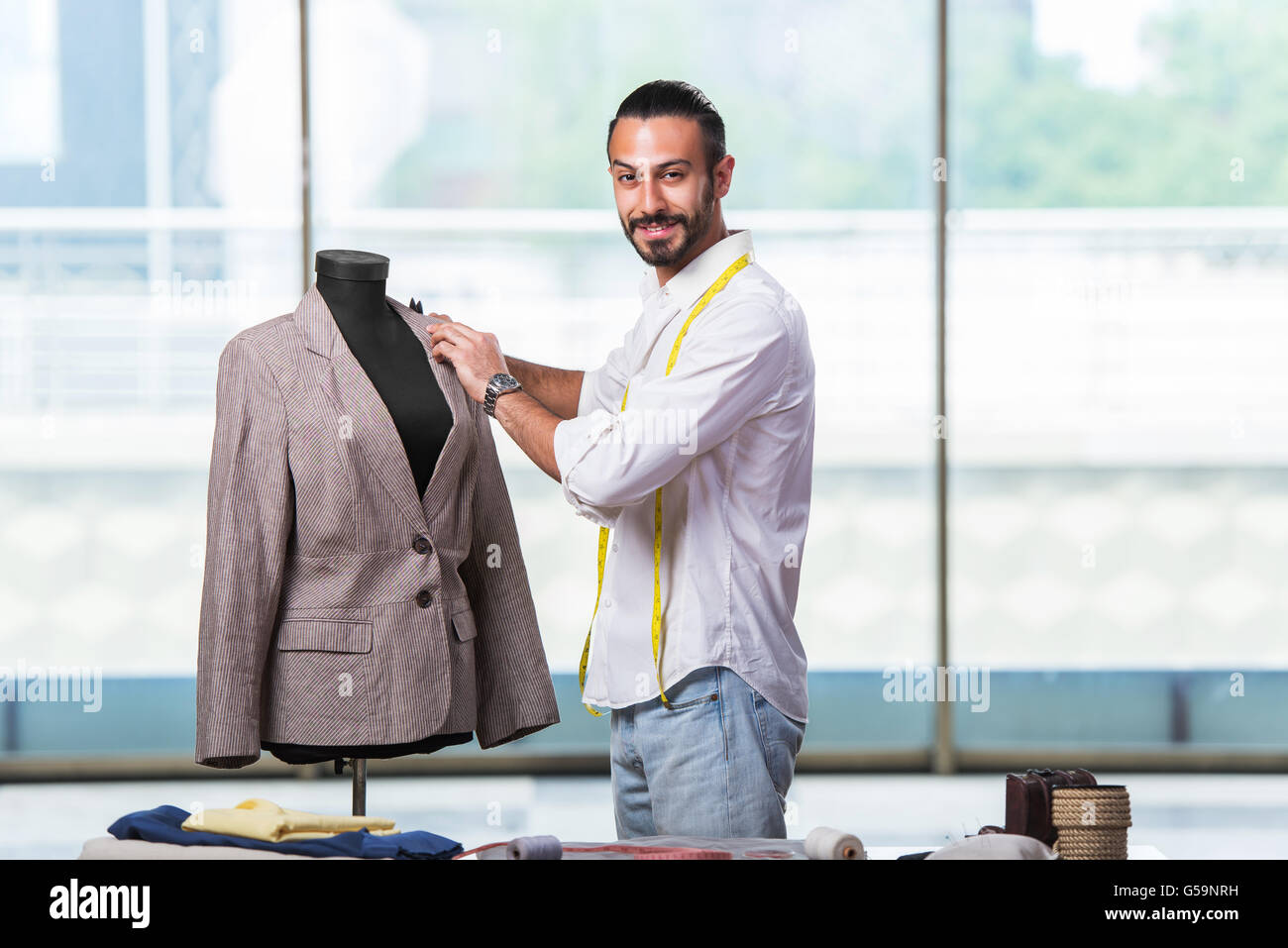 Young tailor working on new clothing design Stock Photo - Alamy