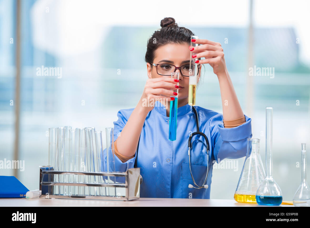 Woman doctor doing chemical tests in laboratory Stock Photo - Alamy
