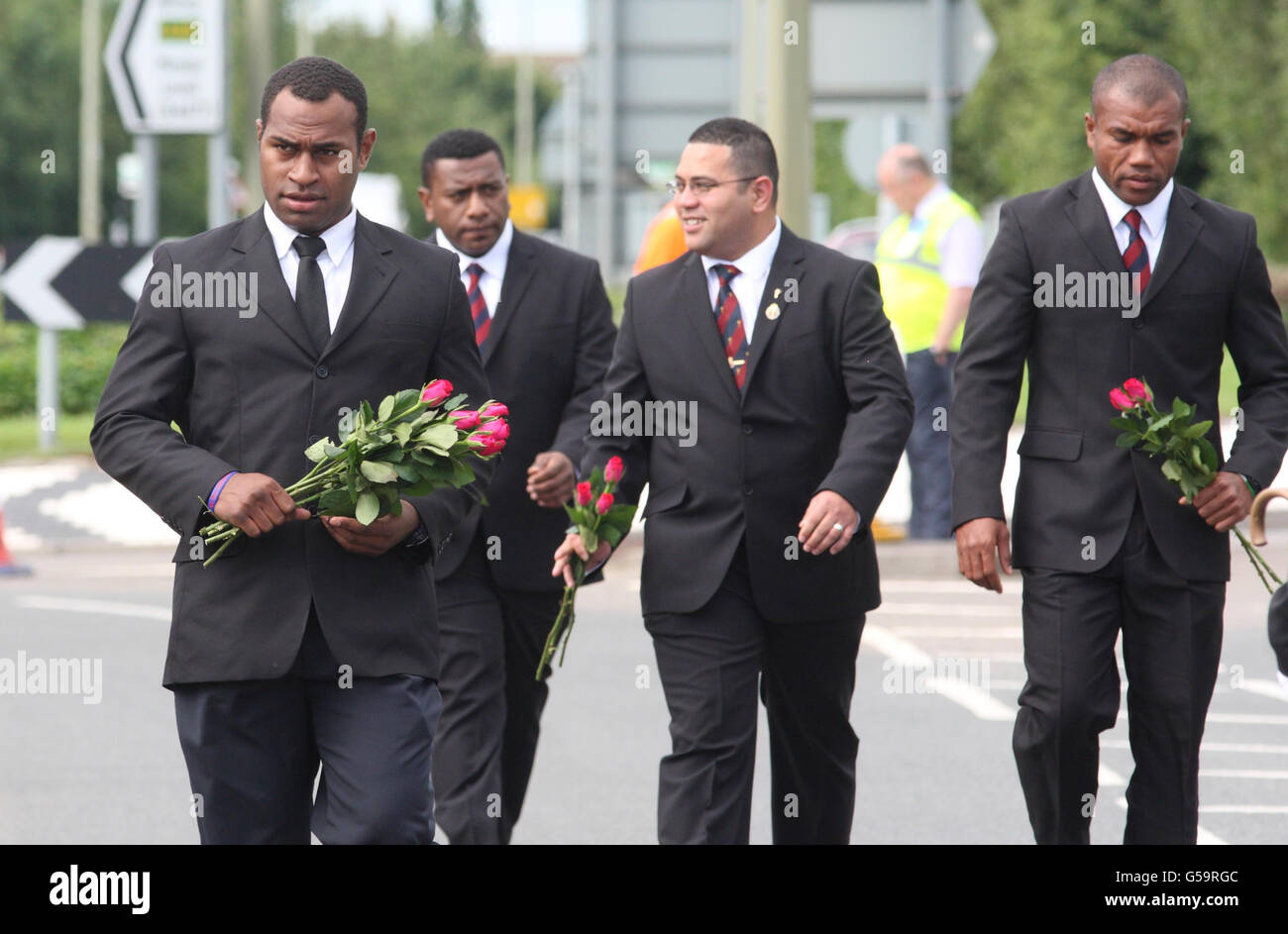 Mourners arrive carrying flowers as they join friends and families of ...