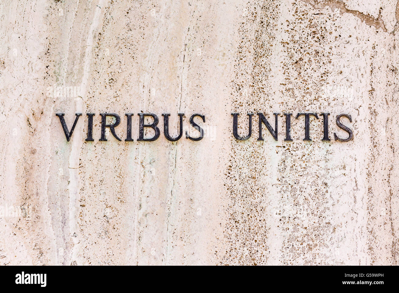 marble slab with a Latin inscription meaning joint forces Stock Photo ...