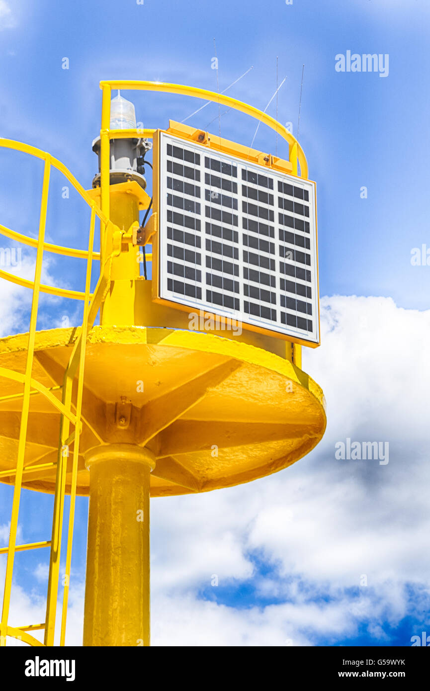 yellow metal lighthouse powered by solar panel Stock Photo - Alamy