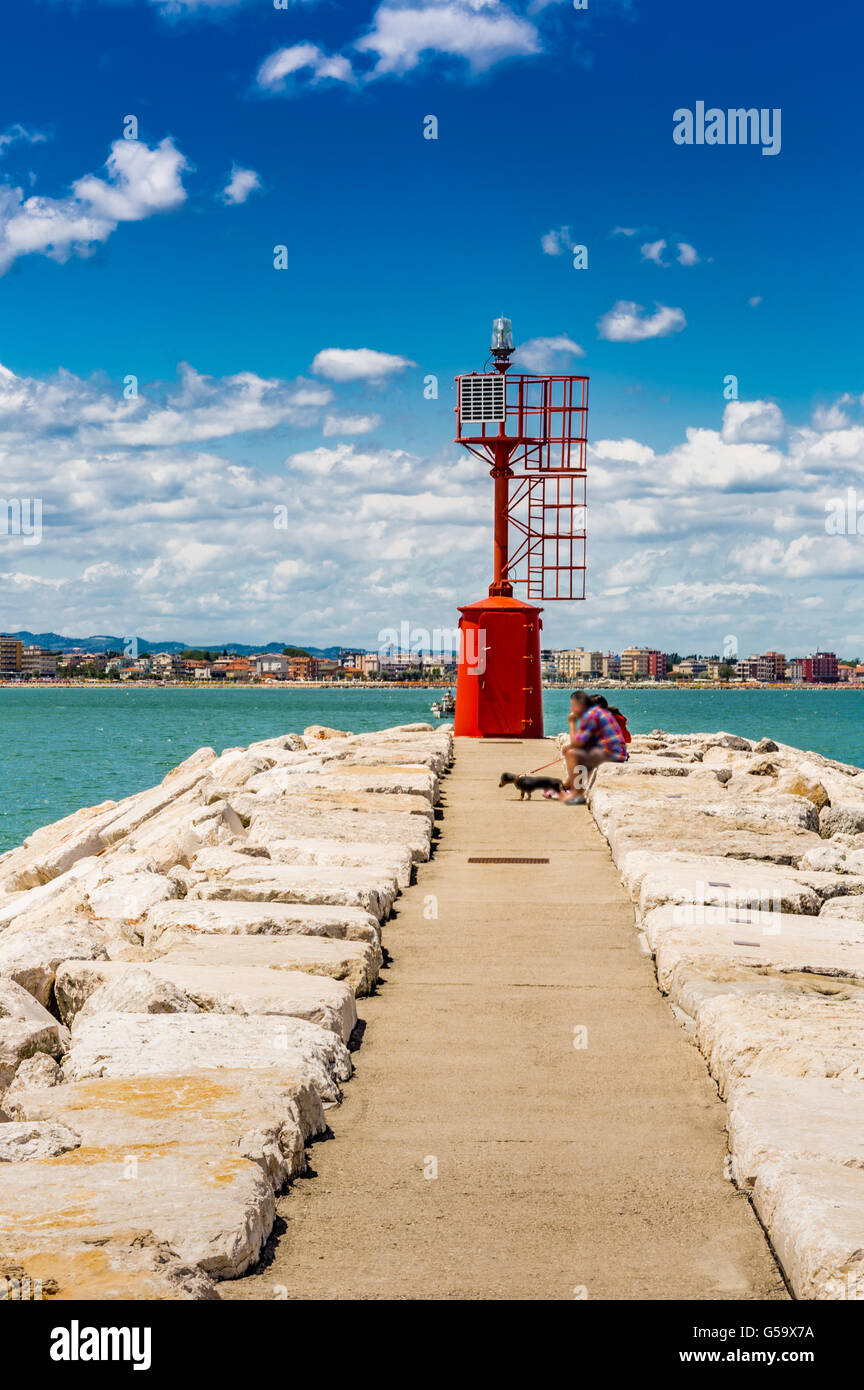red metal lighthouse powered by solar panel on a pier with the Adriatic ...