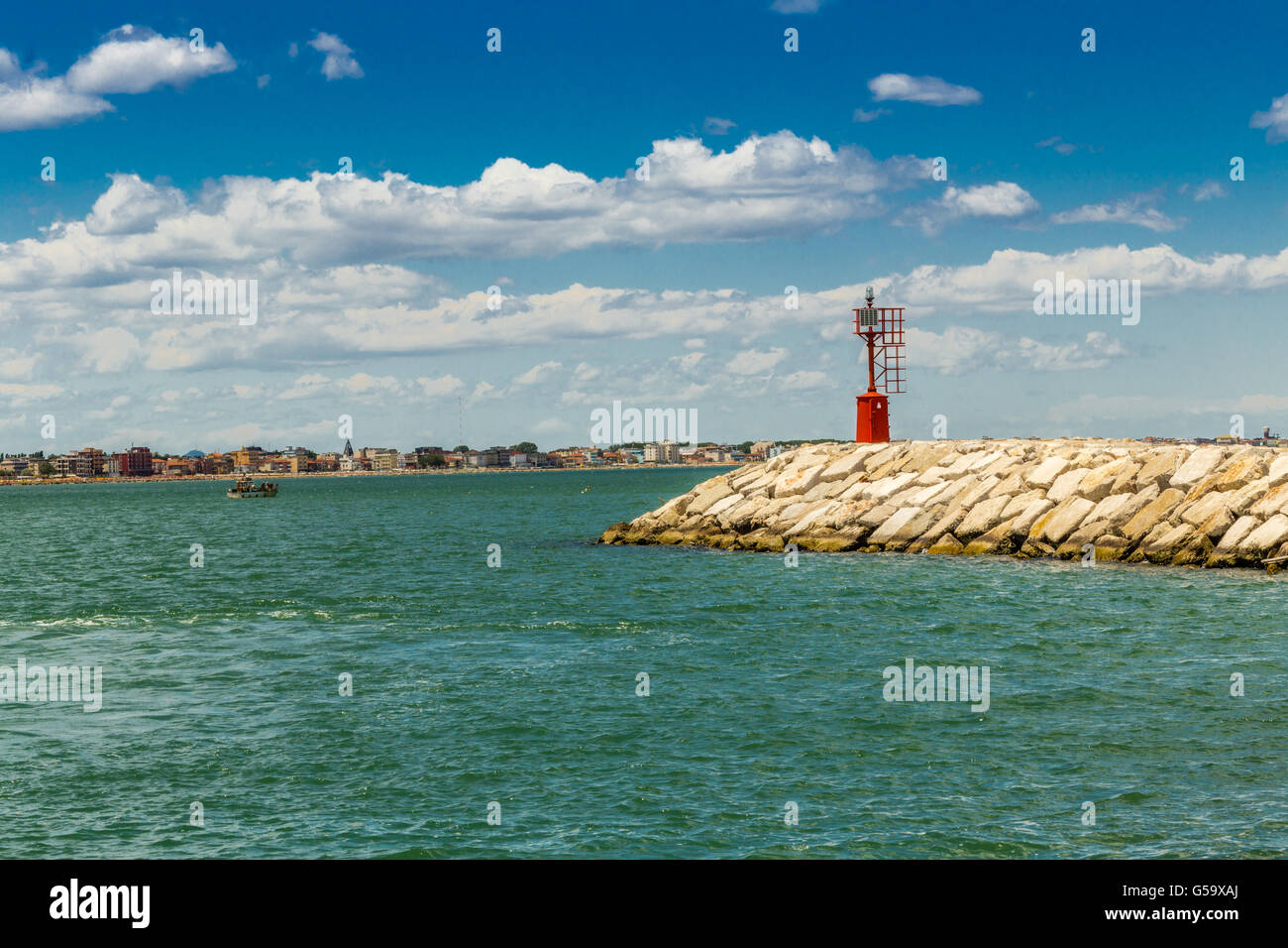 red metal lighthouse powered by solar panel on a pier with the Adriatic ...
