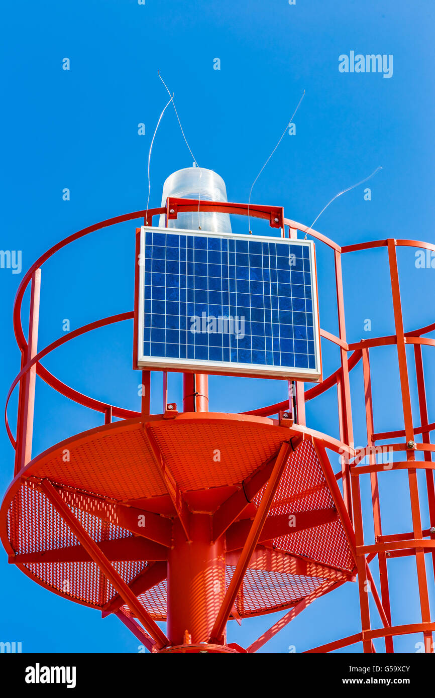 red metal lighthouse powered by solar panel Stock Photo - Alamy
