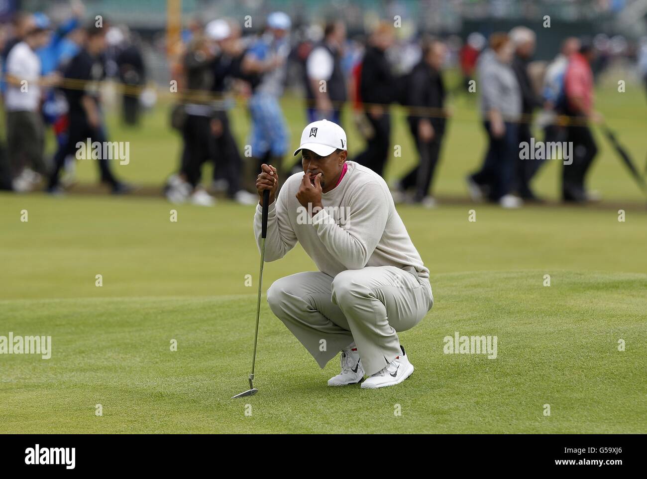 USA's Tiger Woods lines up a putt on the 18th hole during day one of ...