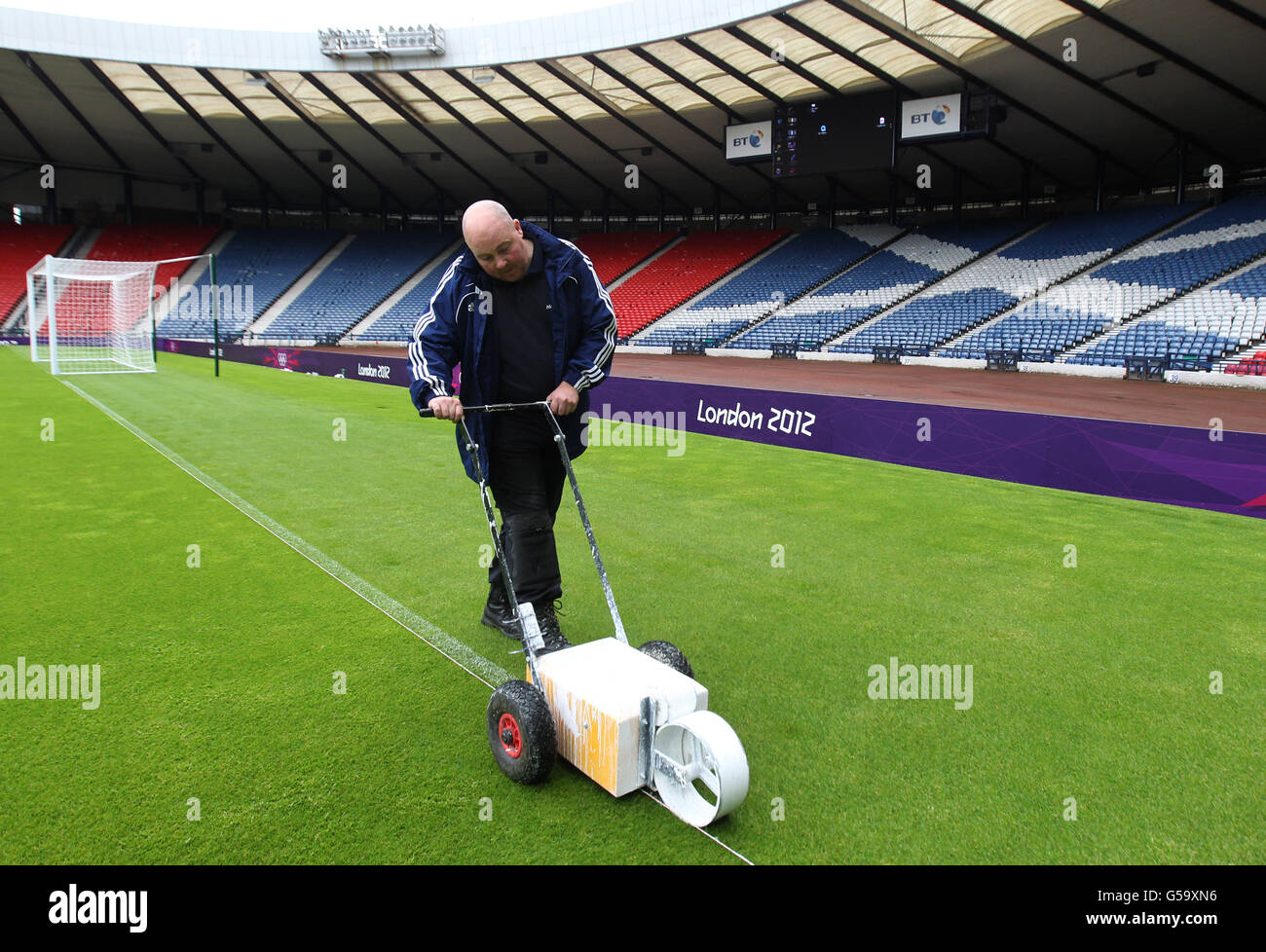 Groundsman Scott McCready lines the pitch ahead of the first Olympic ...