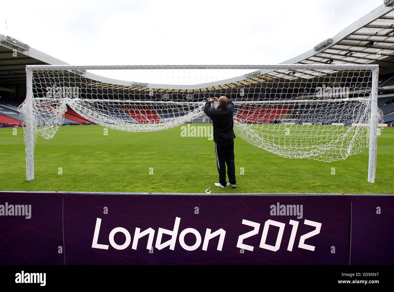Groundsman Scott McCready adjusts the nets ahead of the first Olympic ...