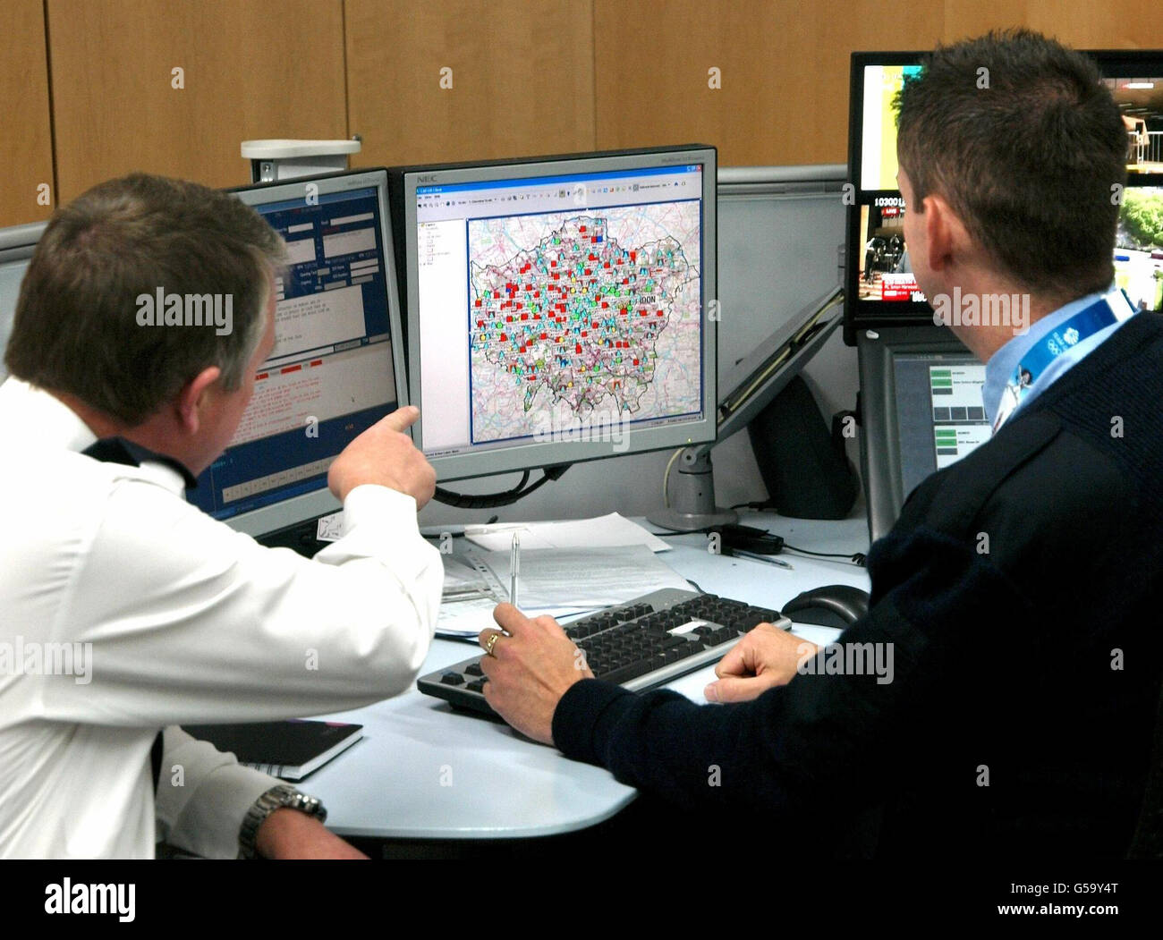 Police officers study a map of London in the Metropolitan Police ...