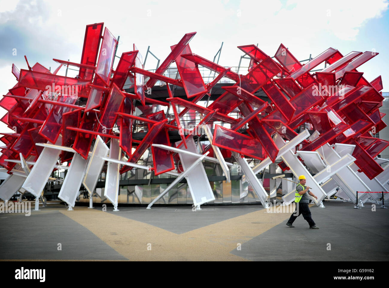A workman carries a brush past the newly completed Coca-Cola Beatbox ...