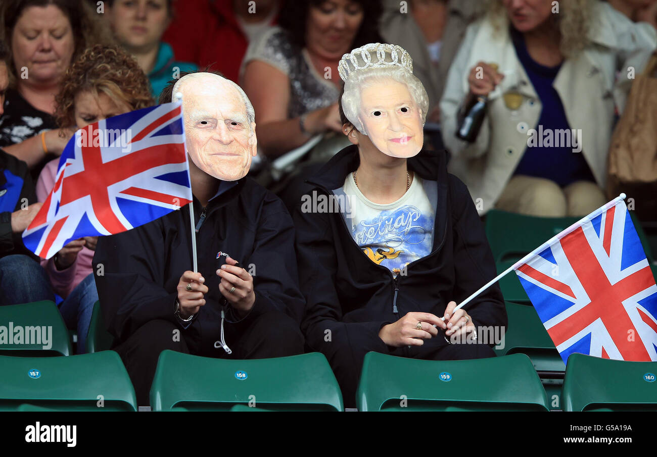 Tennis fans in the stands wear masks of the Queen and Prince Philip ...