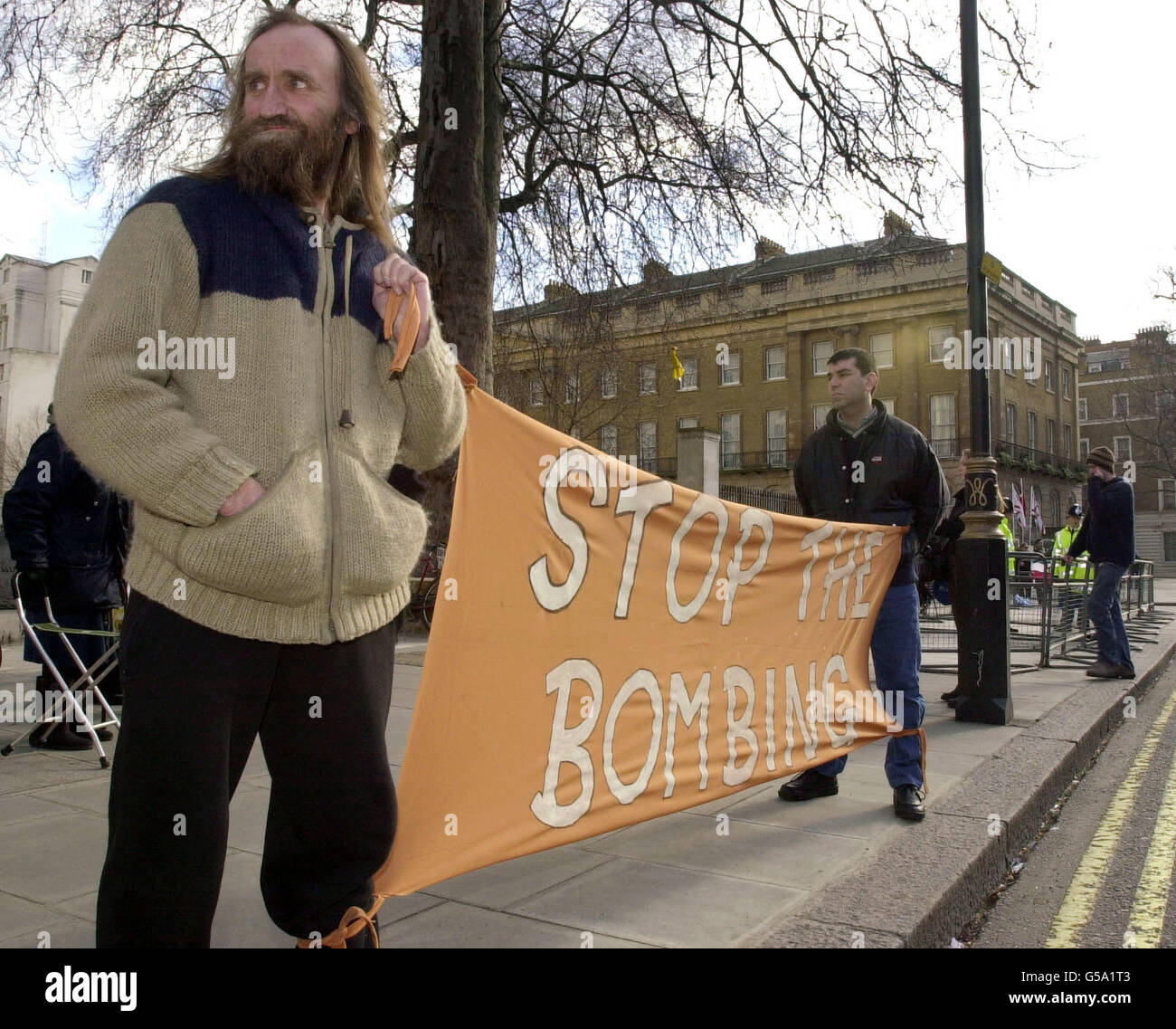 Demonstrators, with a banner reading 'Stop the Bombing', protest ...