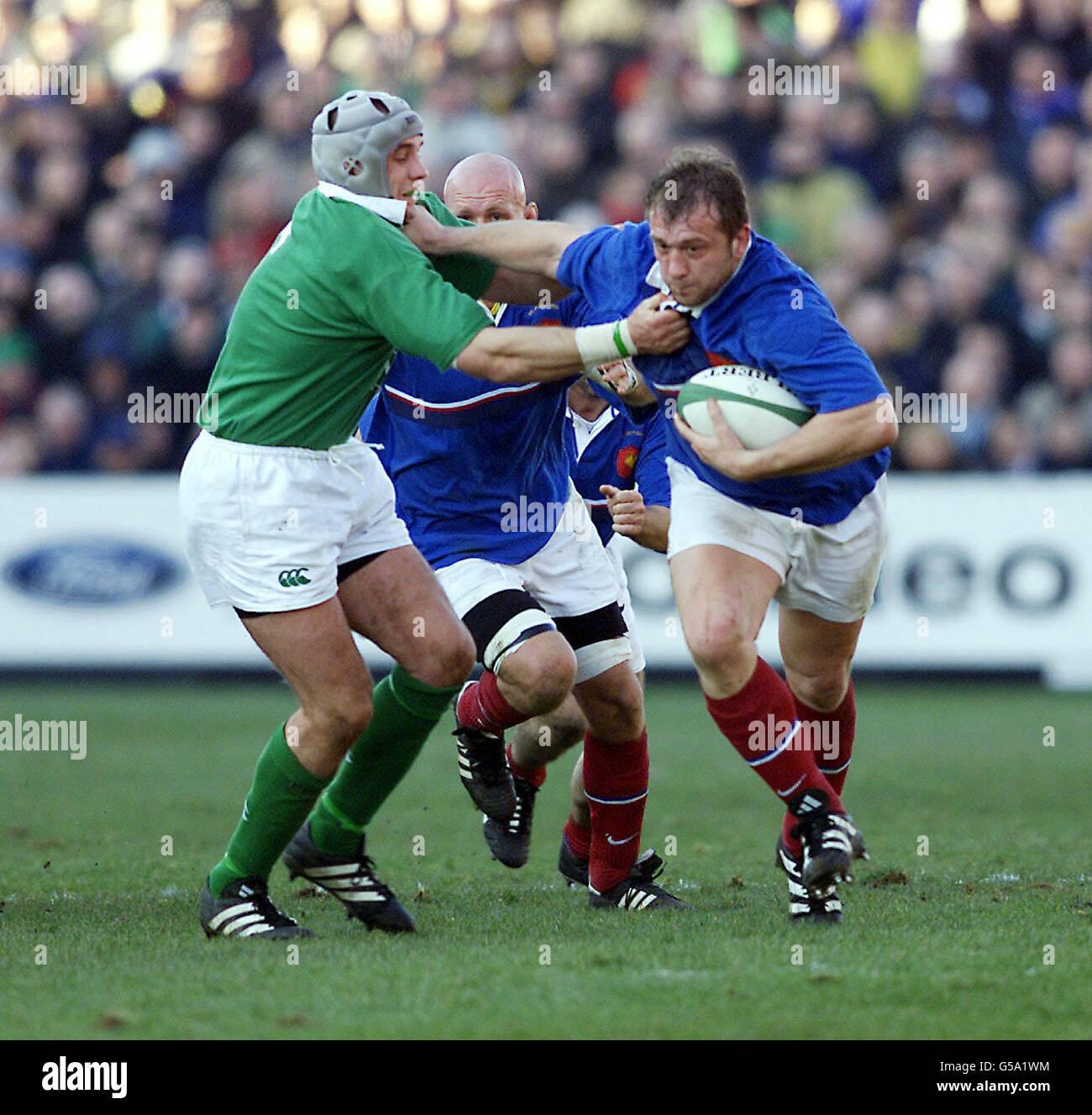 France's Christoph Juillet (right) is held by Alan Quinlan, during ...