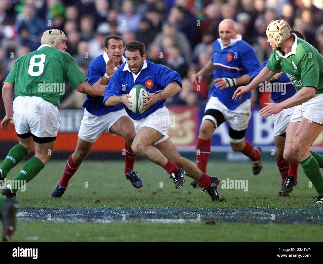 France's Philippe Carbone (centre) breaks through the Irish defence ...