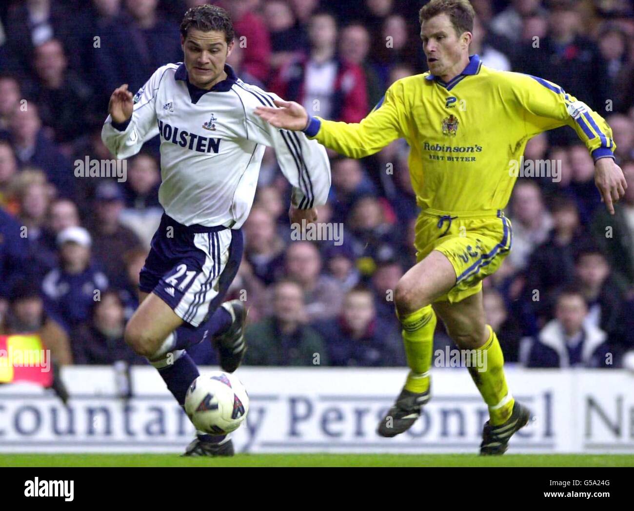 Tottenham Hotspur's Luke Young (L) runs with the ball past Stockport ...