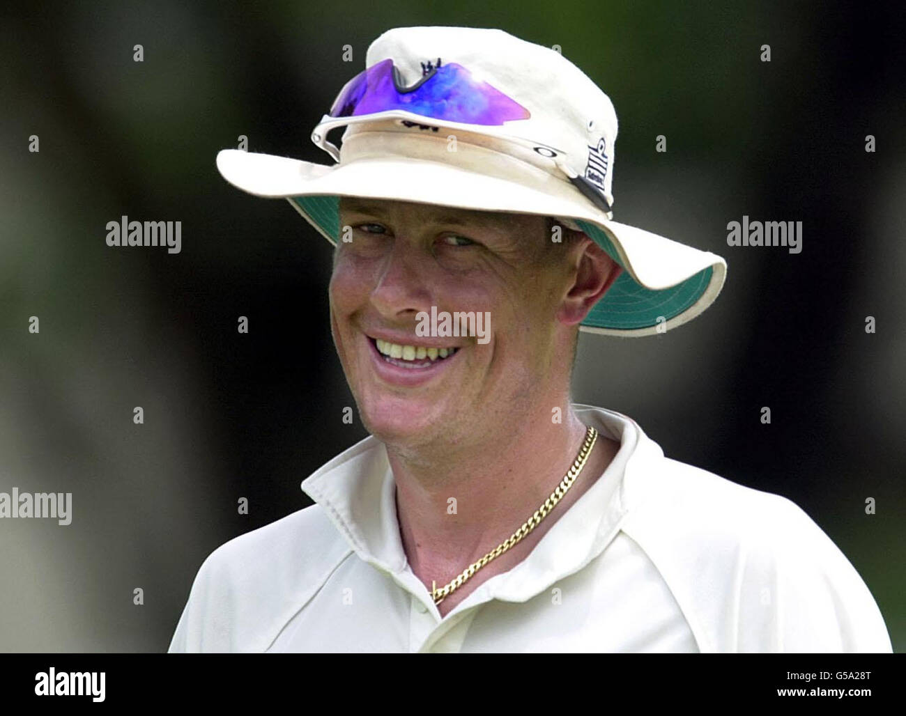 England bowler Ashley Giles gives a smile as he returns to the boundary ...