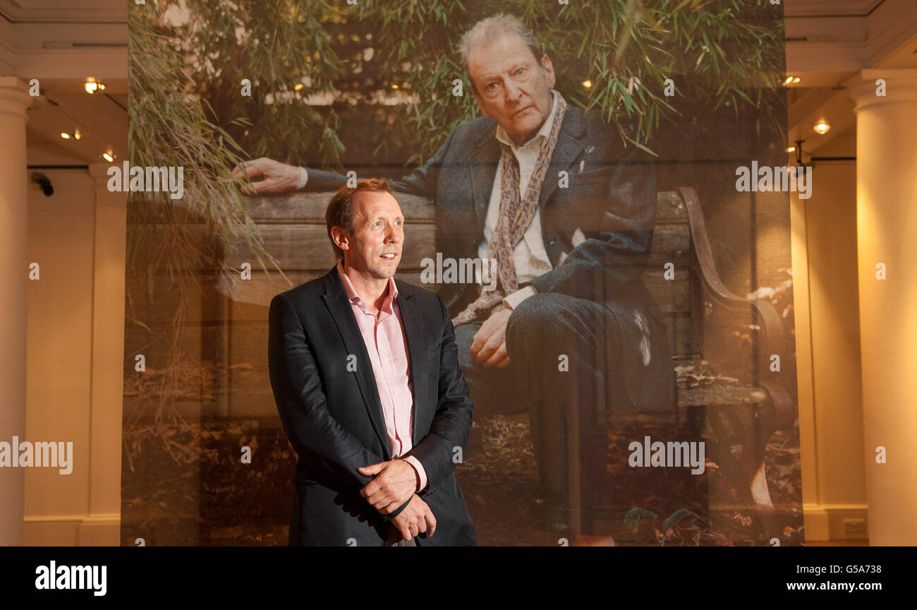 Photographer David Dawson poses with a print of his portrait of Lucian ...