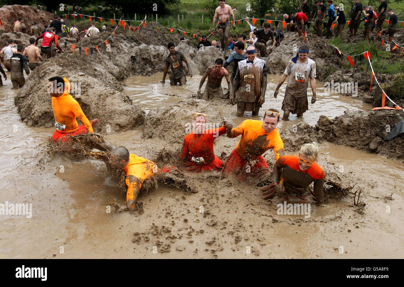 Participant tackle the Mud Mile obstacle during the 2012 Tough Mudder ...