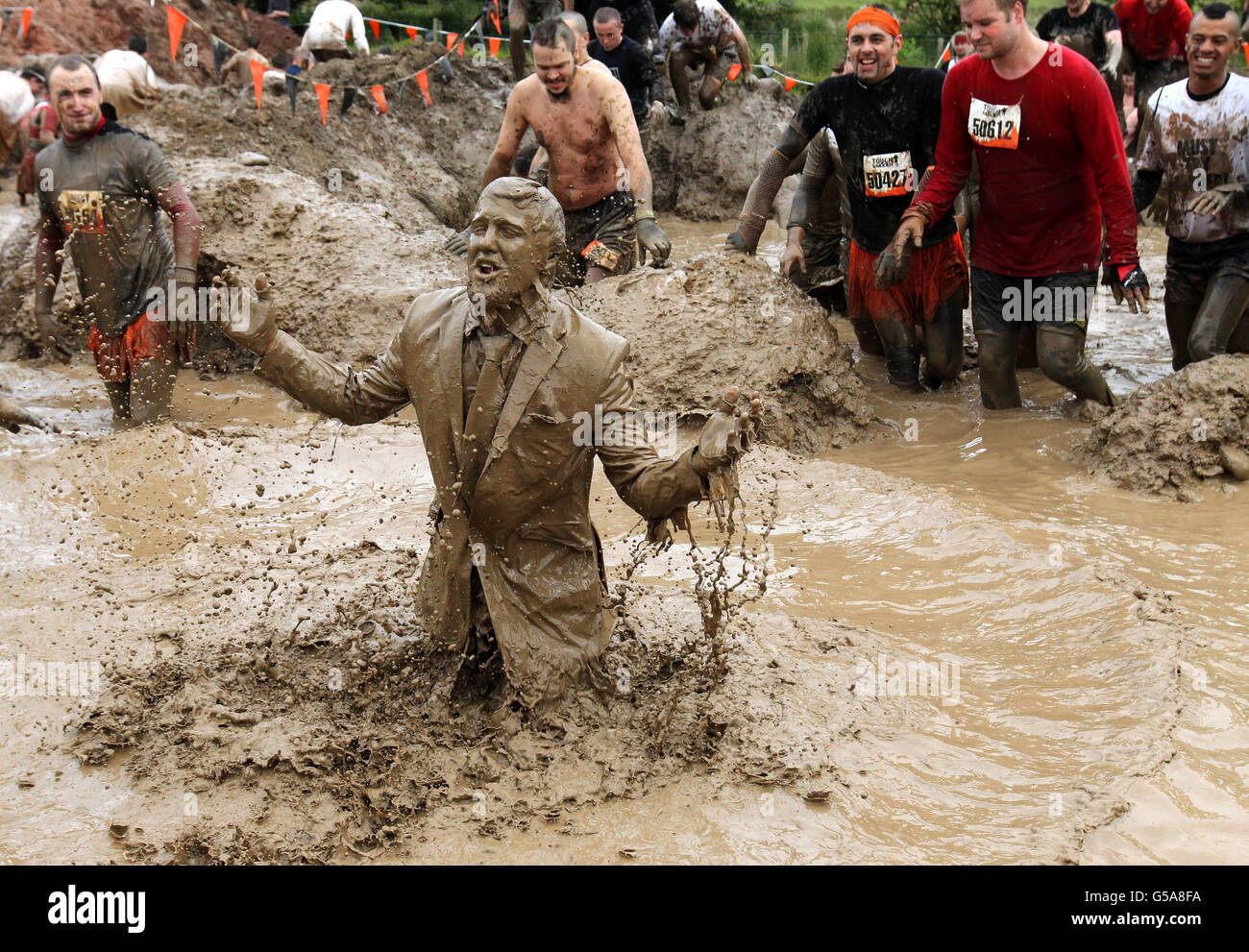 Keegan Rannoch in a mud covered suit in the Mud Mile obstacle as he ...