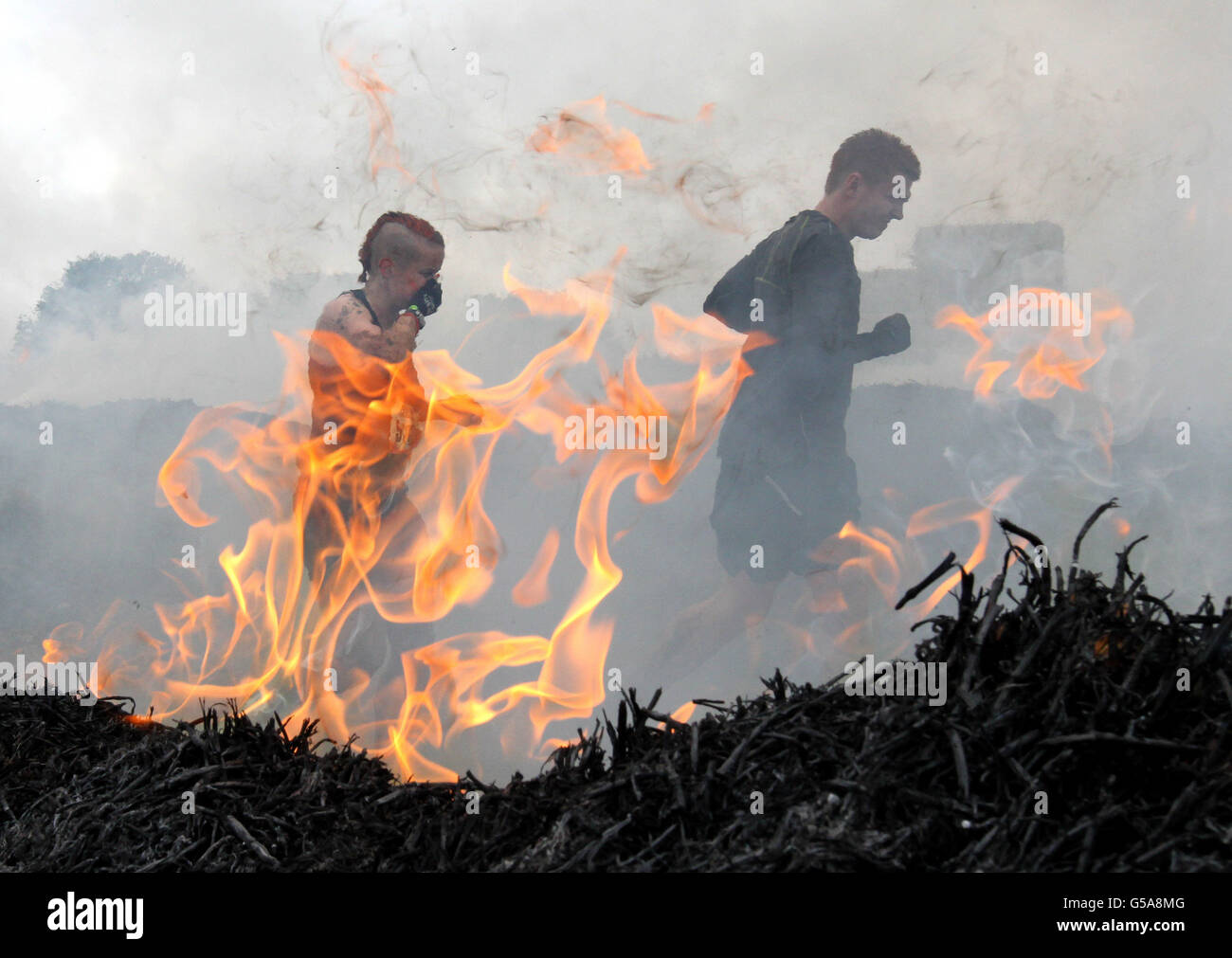 Participants pass through the Firewalker obstacle during the 2012 Tough ...