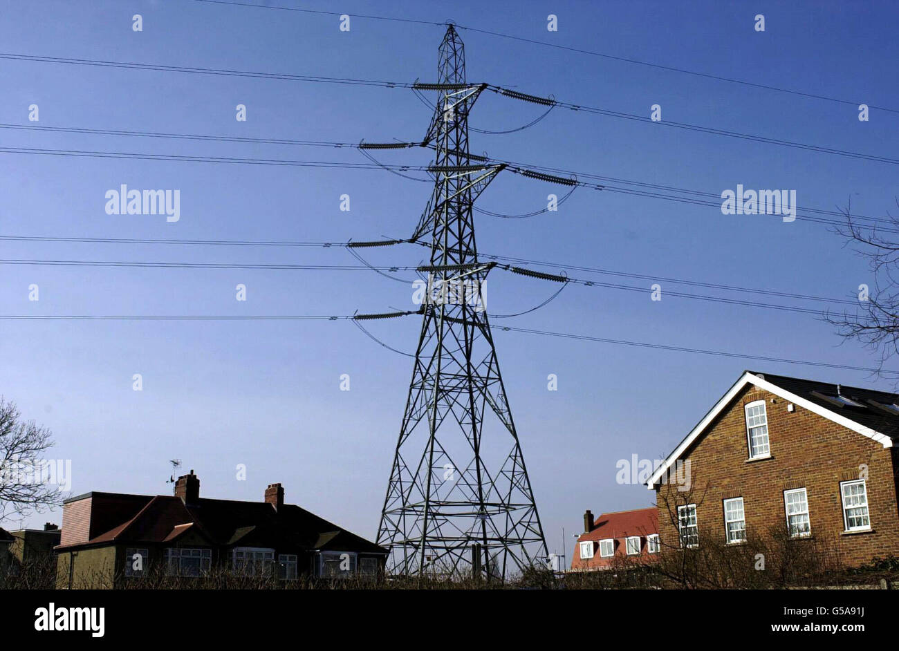 An electricity pylon in Mitcham Surrey near residential homes Stock Photo - Alamy