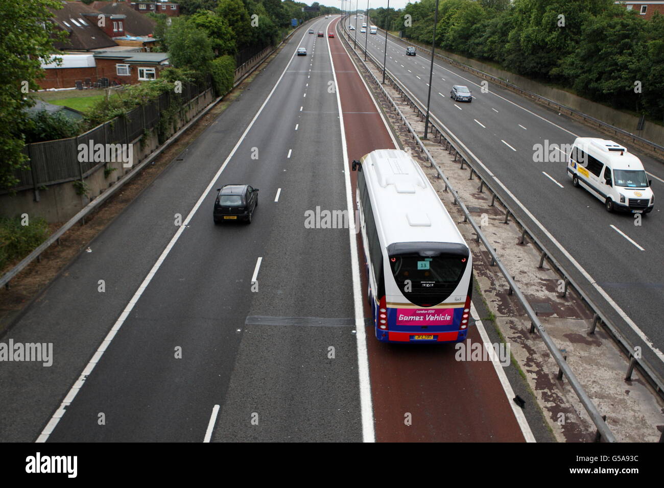 An official Olympics vehicle (right) uses the first of the Olympic ...