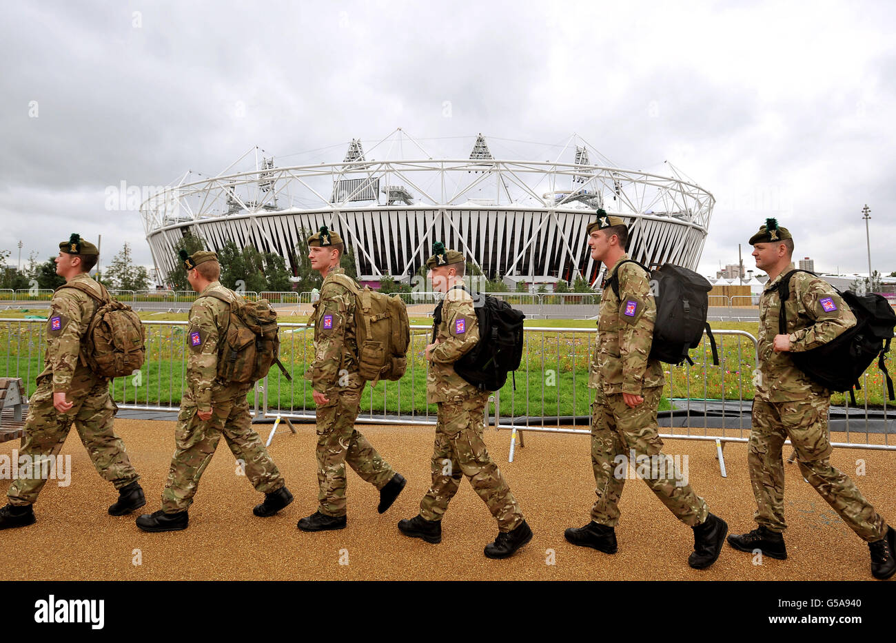 A group of soldiers from the Royal Regiment of Scotland march in front ...