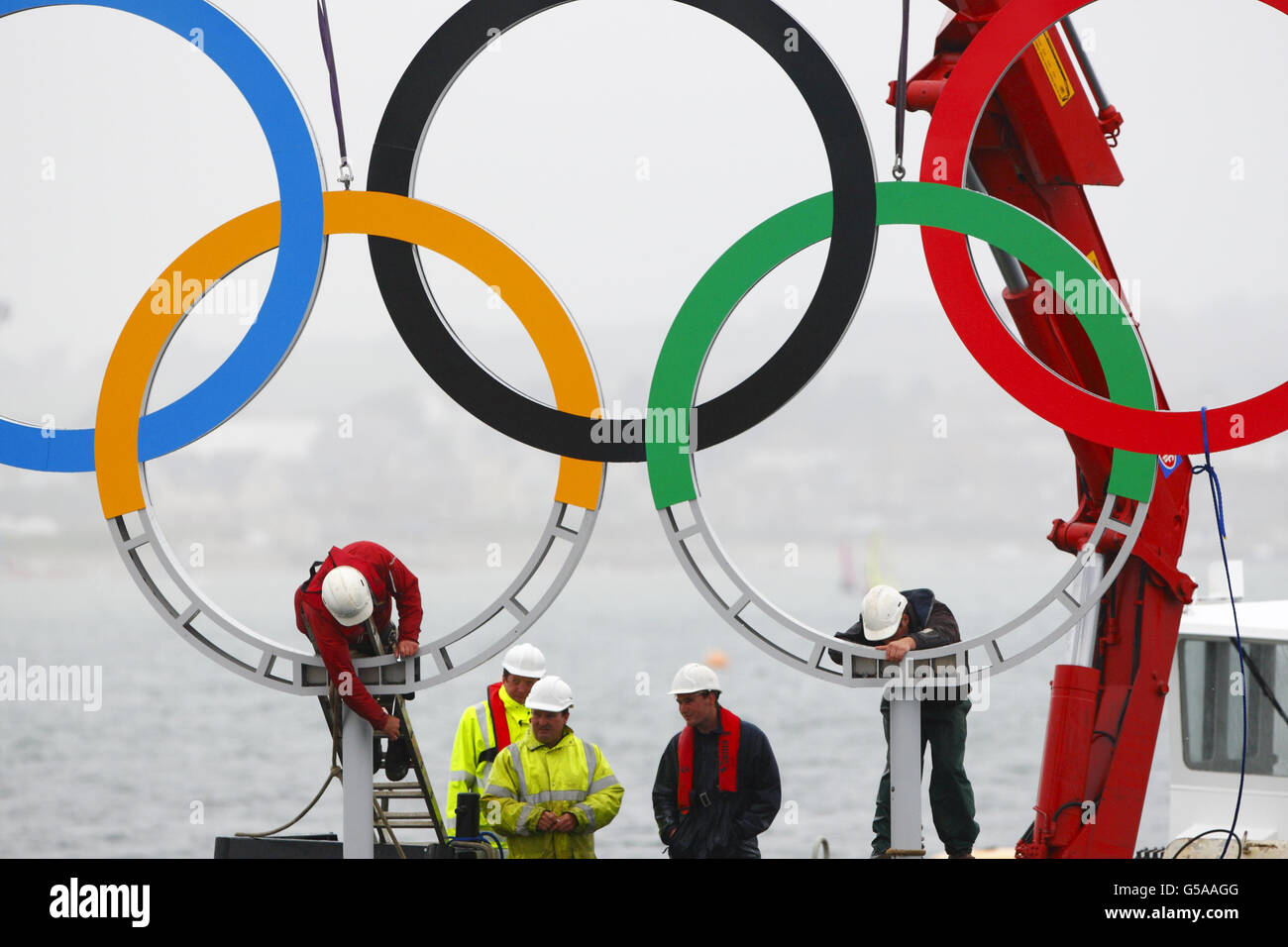 Engineers install Olympic rings in the sea at the Weymouth and Portland ...
