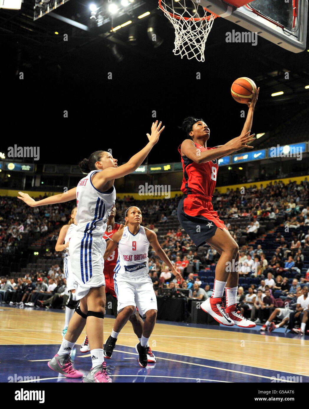 USA's Angel McCoughtry drives to the basket past Great Britains Azania ...