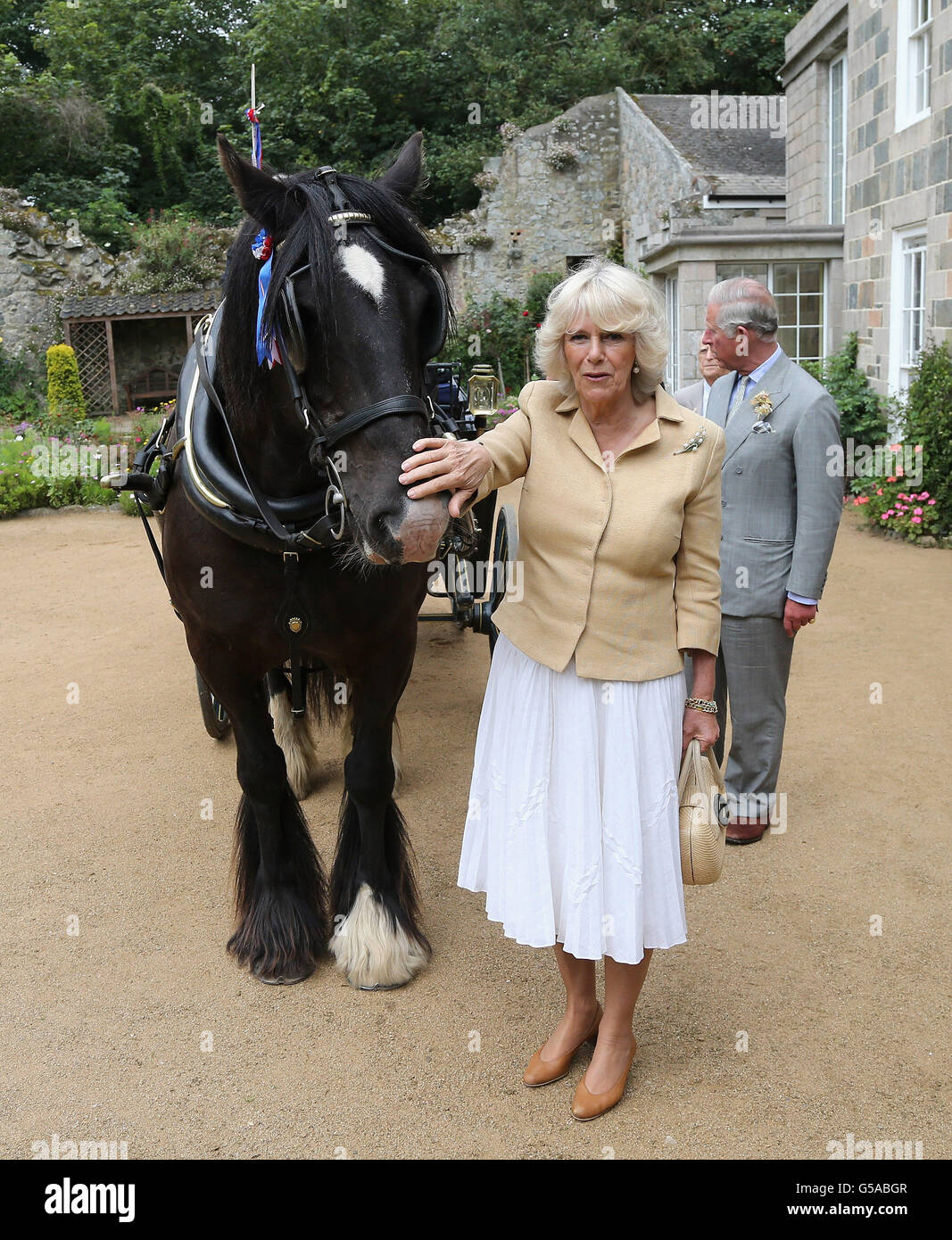The Duchess of Cornwall and the Prince of Wales pose with a horse ...