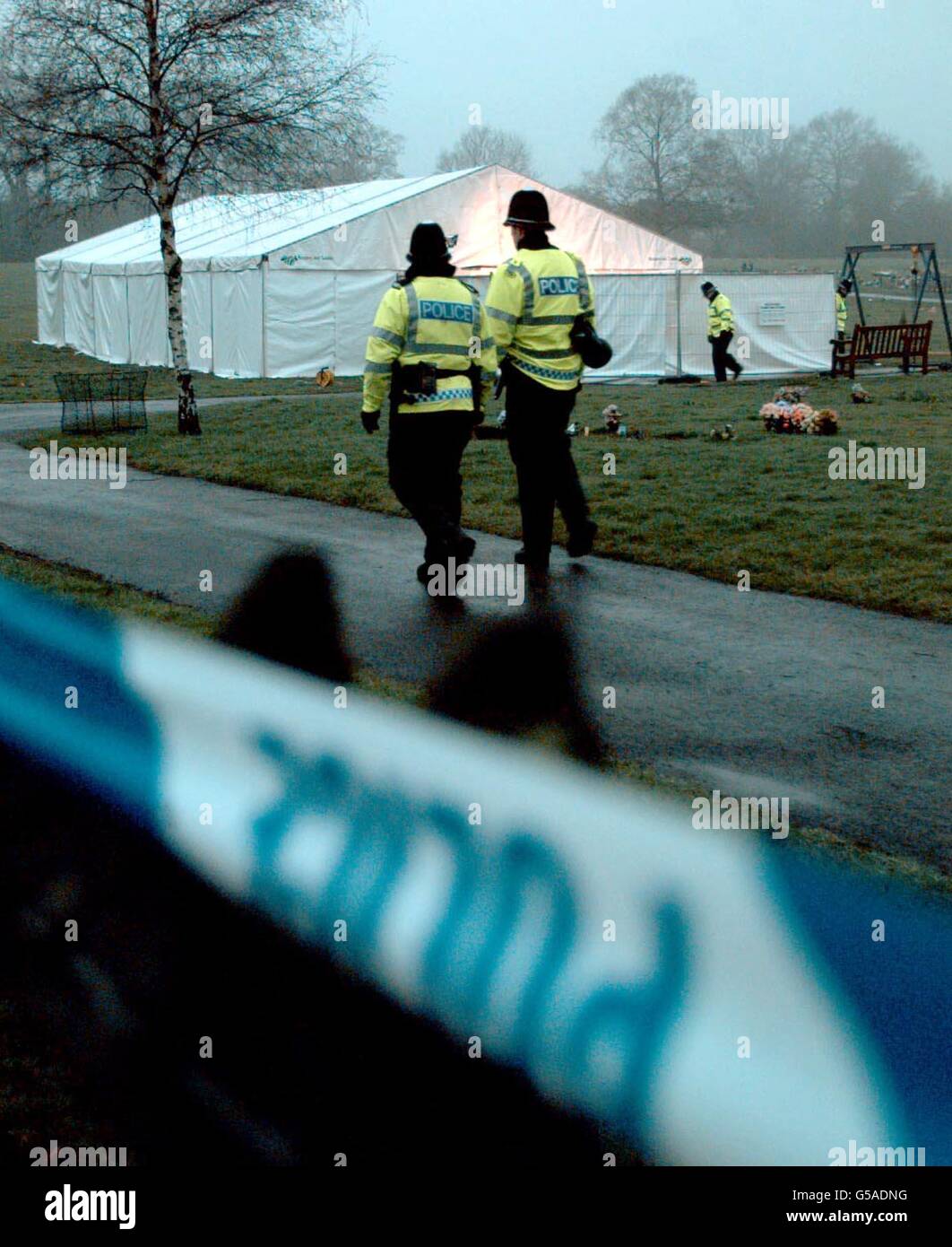 Police officers near the tent set up to exhume the remains of James ...