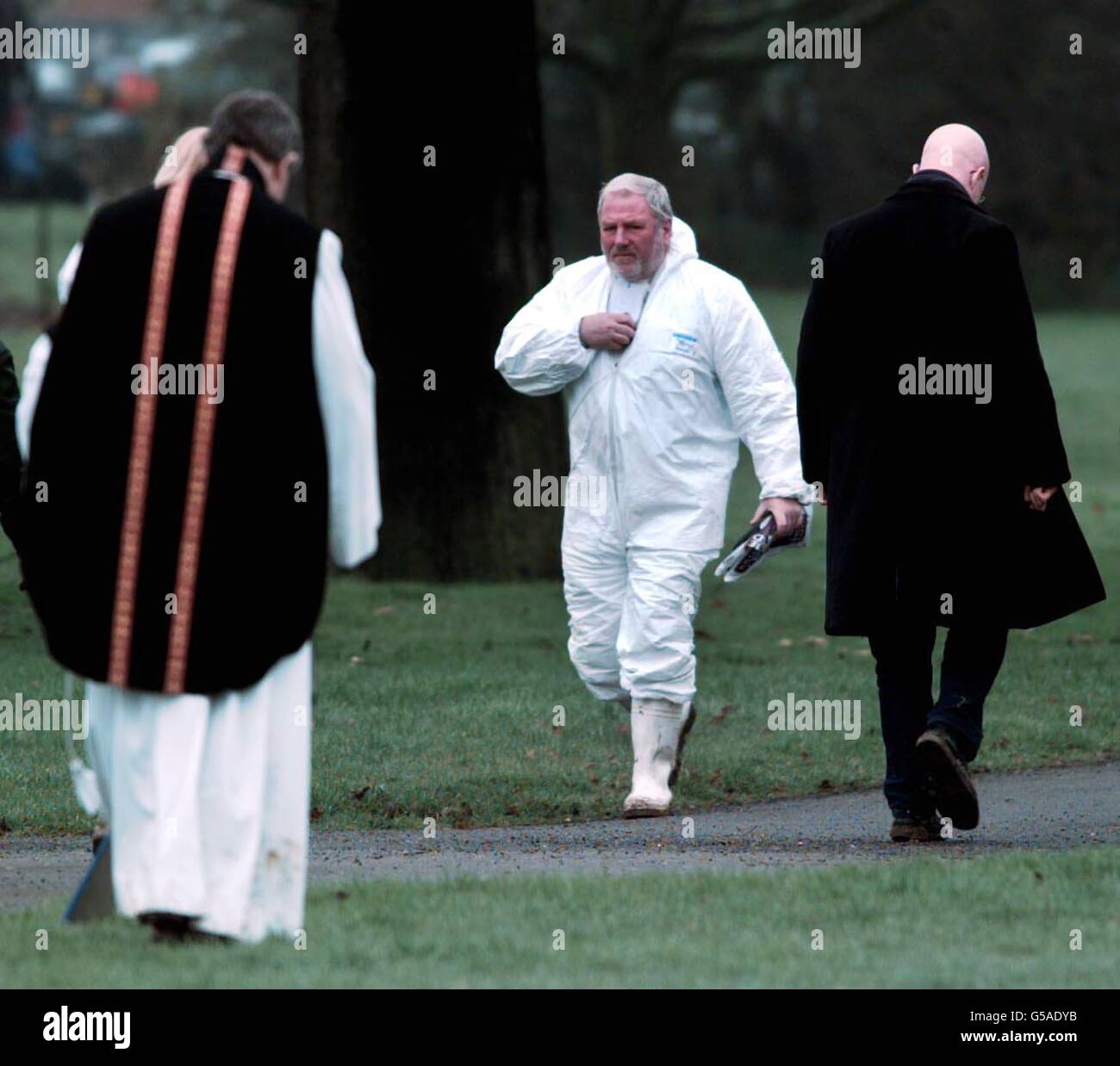 A member of the clergy and others leave the site after the remains of ...