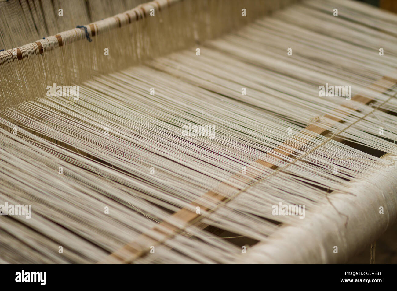 A closeup image of an old weaving Loom and thread of yarn Stock Photo ...