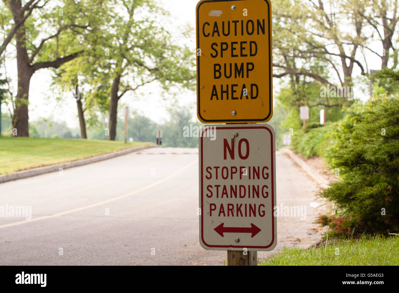 Speed Bump Ahead, No Stopping, No Standing, No Parking Sign Stock Photo ...