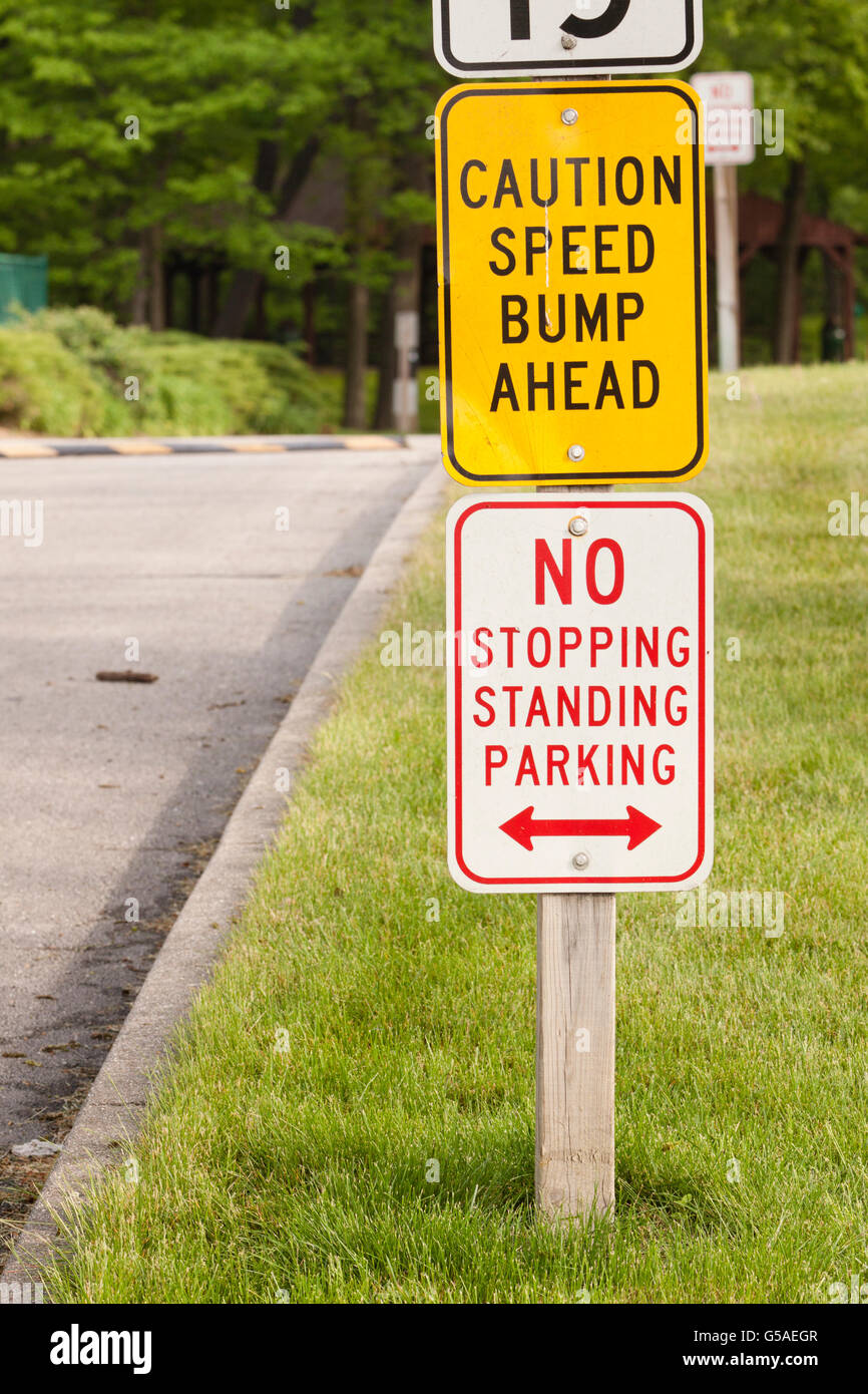 Speed Bump Ahead, No Stopping, No Standing, No Parking Sign Stock Photo ...
