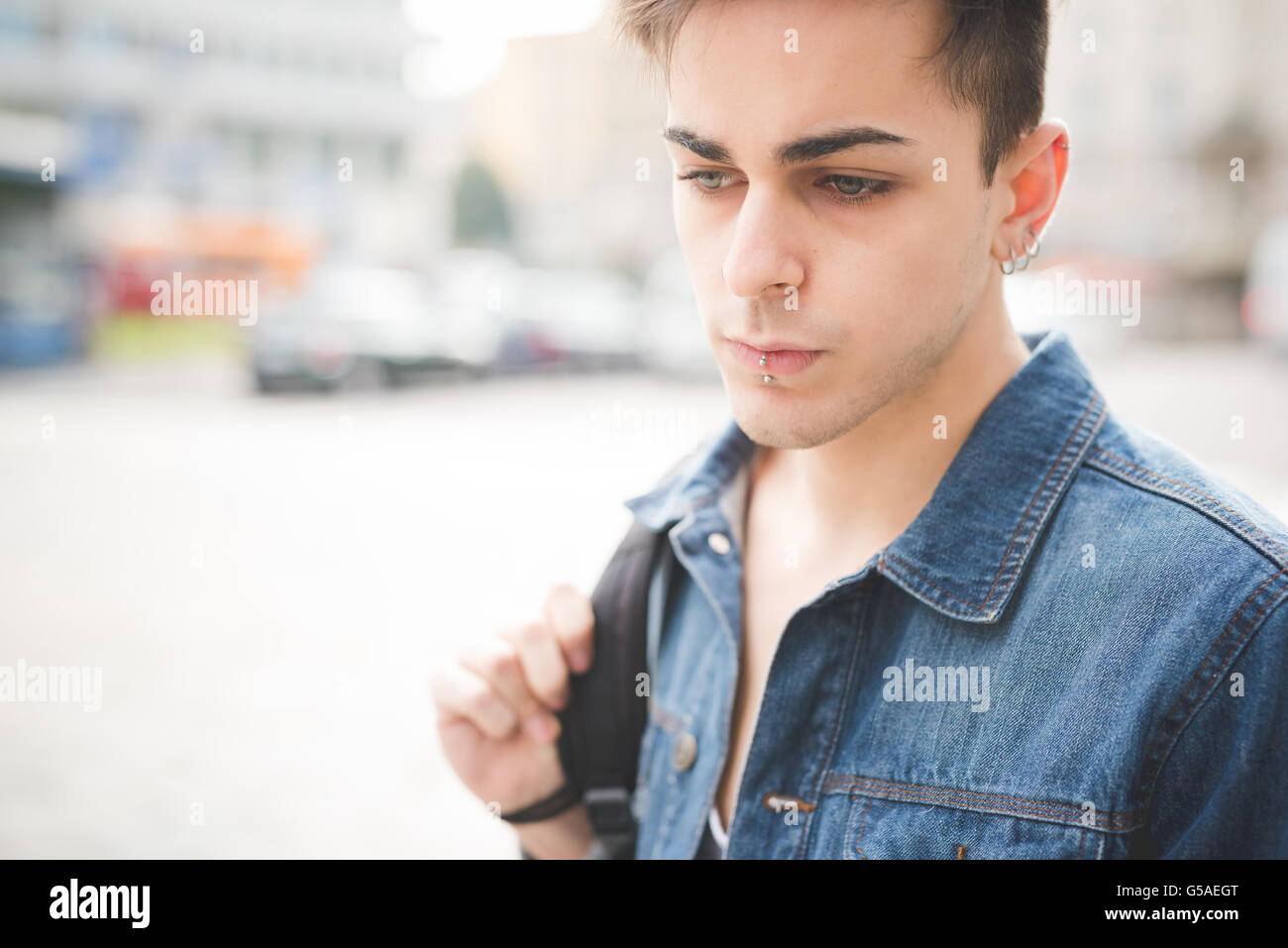 Half length of young beautiful pale blue eyes millennial man outdoor in ...