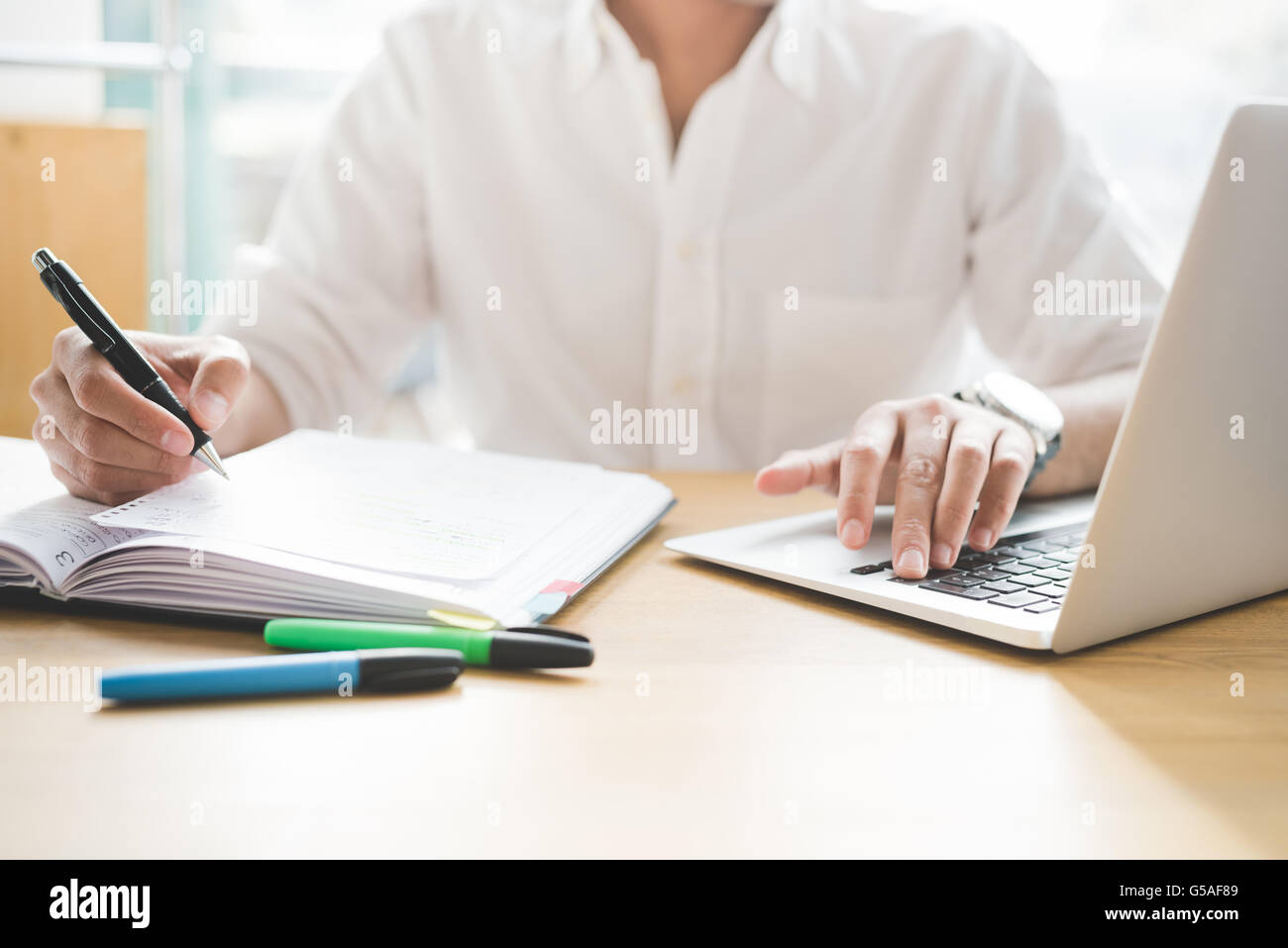 From the neck down view of contemporary businessman tapping the ...