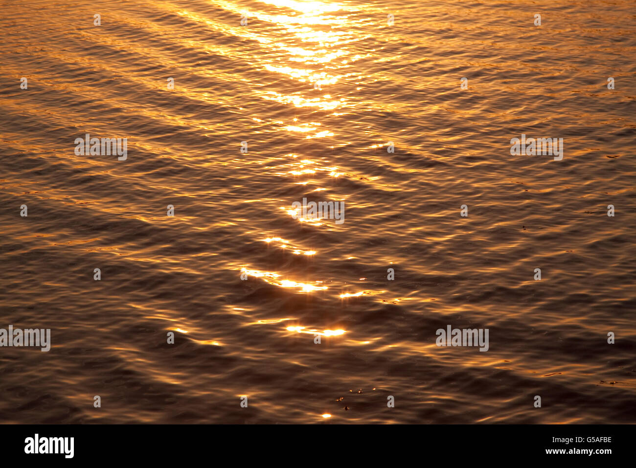 Sun Sparkling on Sunset Rippled Lake Stock Photo - Alamy