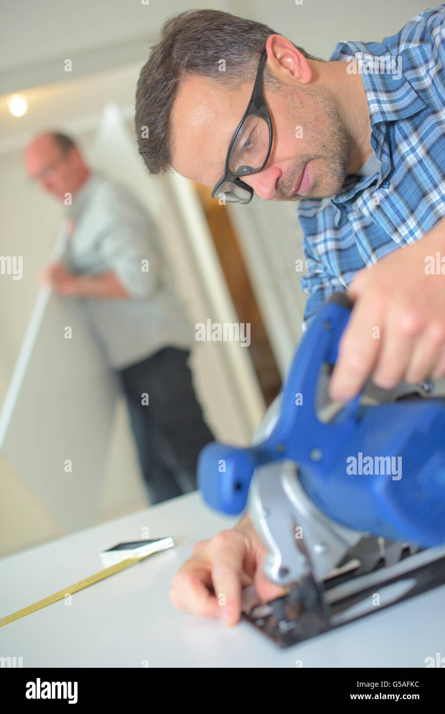 Handyman using a band saw Stock Photo - Alamy