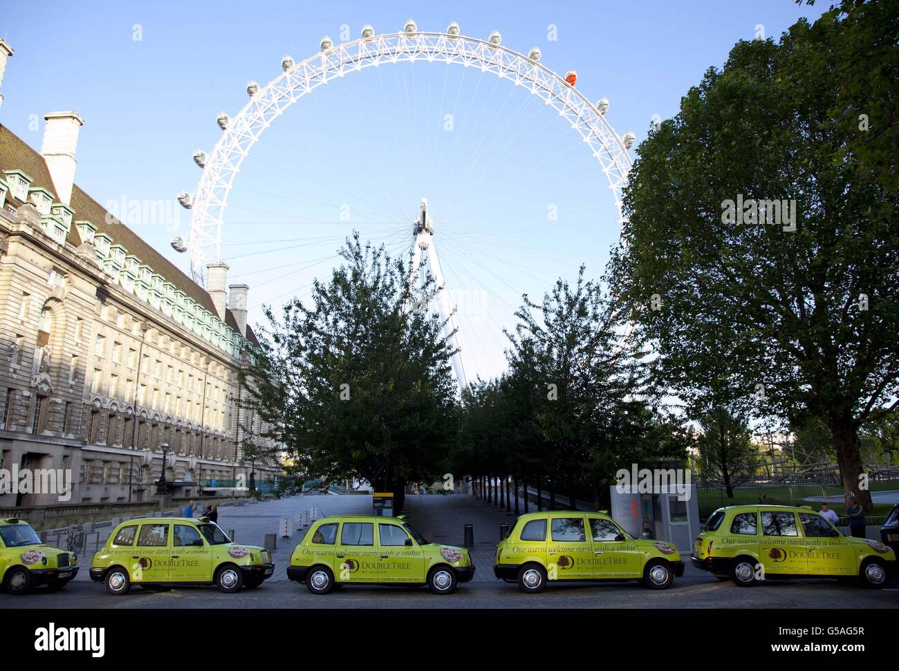 Some of the exclusive fleet of 30 branded taxis drive passed the London ...