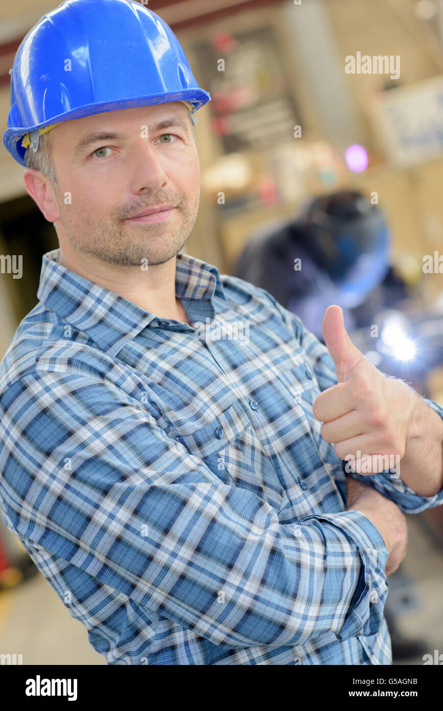 worker thumbs up Stock Photo - Alamy