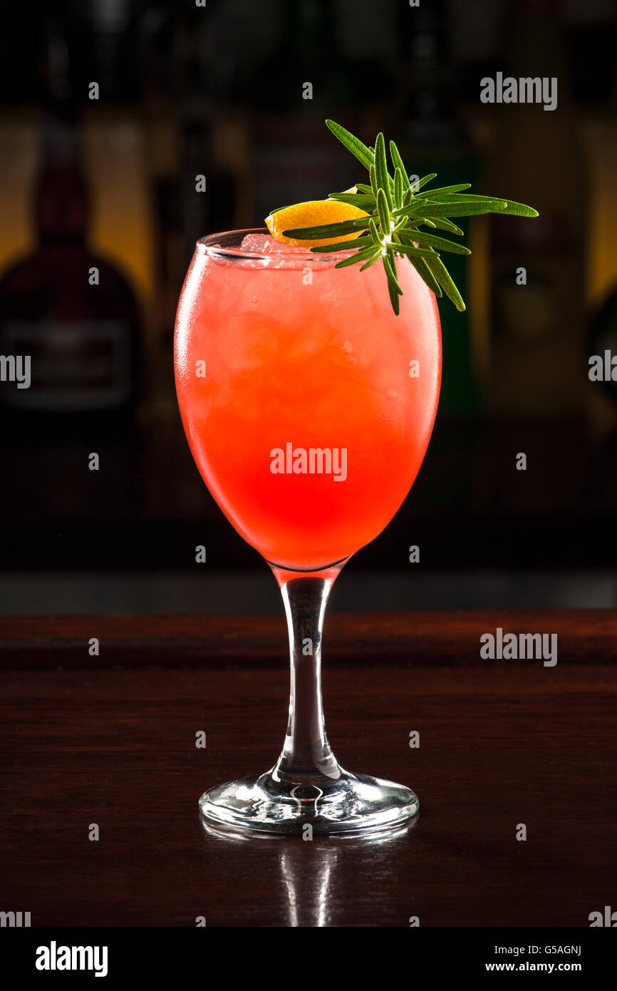 Raspberry cocktail with rosemary, served in vine glass Stock Photo - Alamy