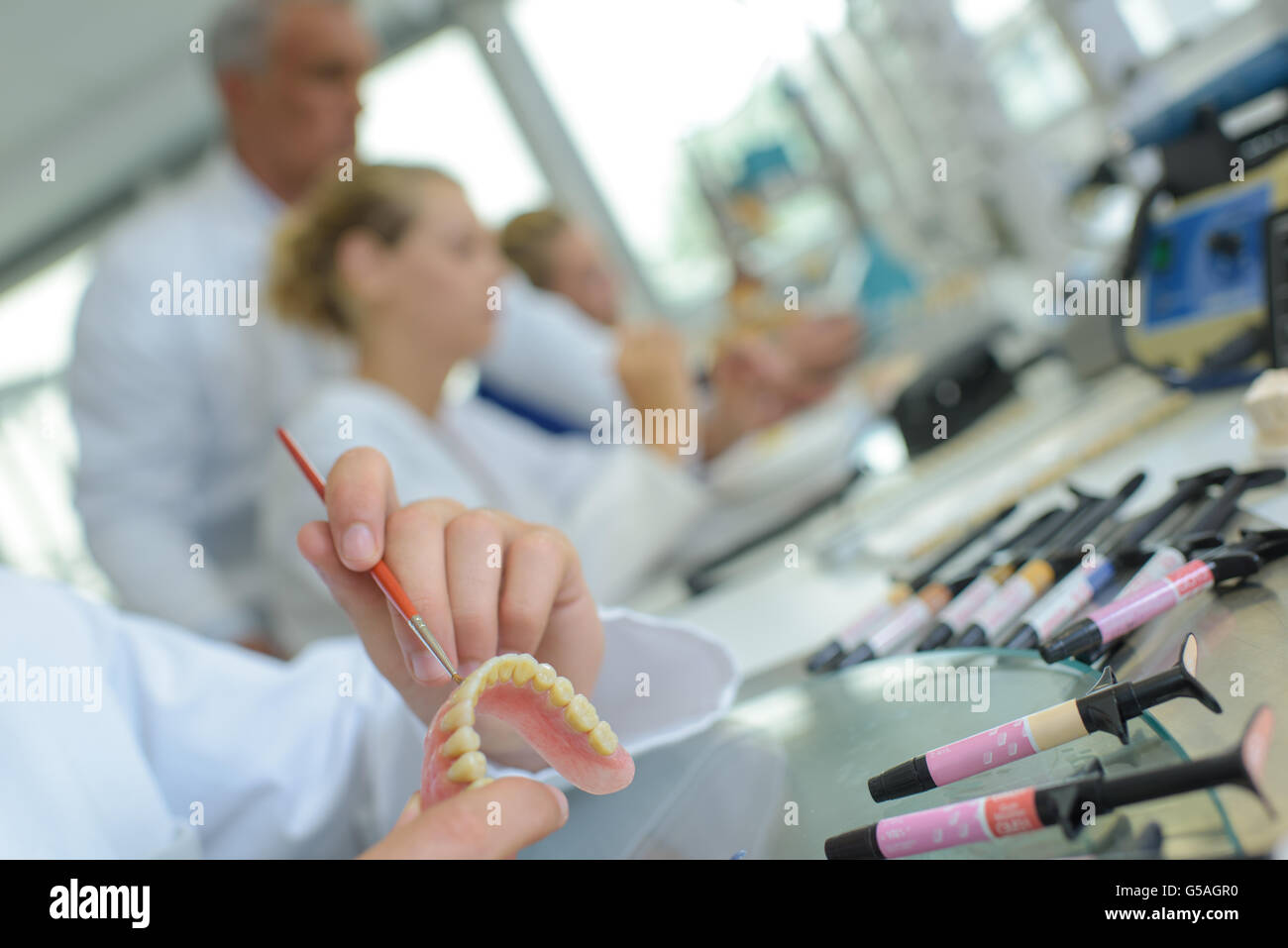 painting artificial teeth Stock Photo - Alamy
