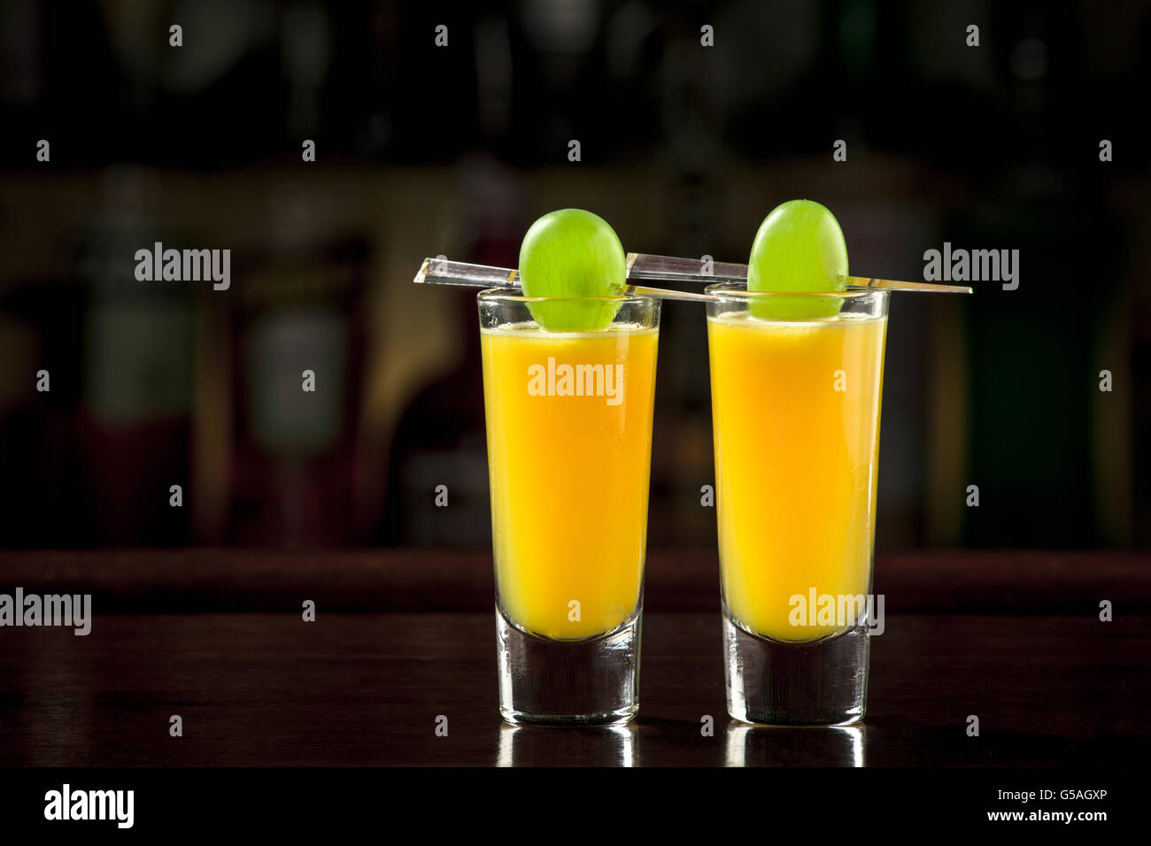 Fruity yellow shots with green grape Stock Photo - Alamy