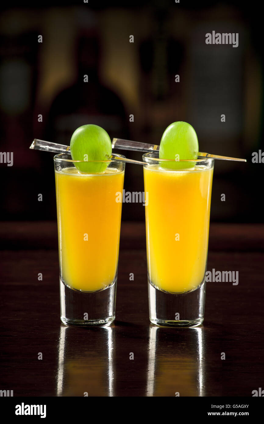 Fruity yellow shots with green grape Stock Photo - Alamy