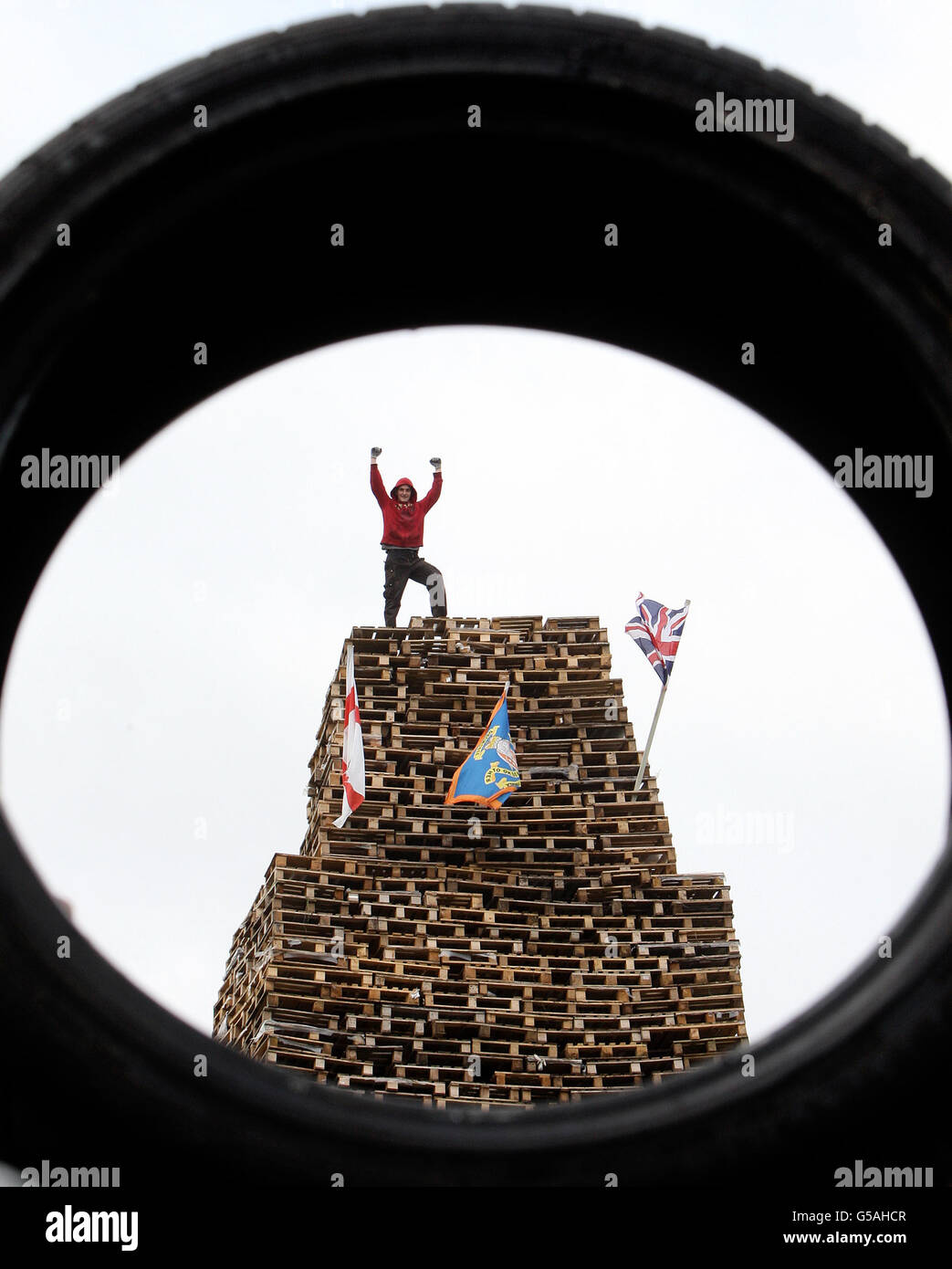 A man stands on top of one of the biggest 11th night bonfires at New ...