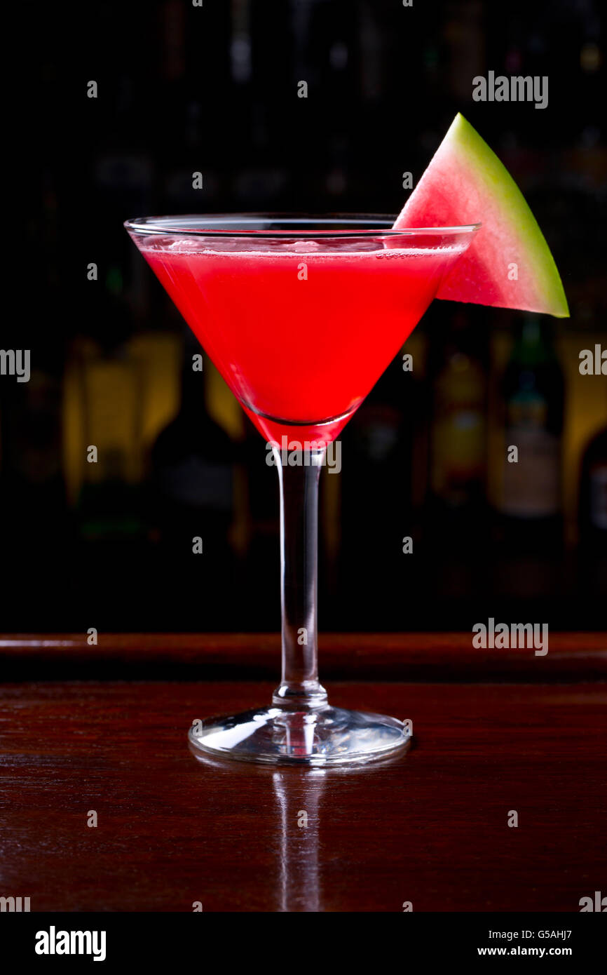 Watermelon Tini with slice of fruit, standing on dark wooden bar Stock ...
