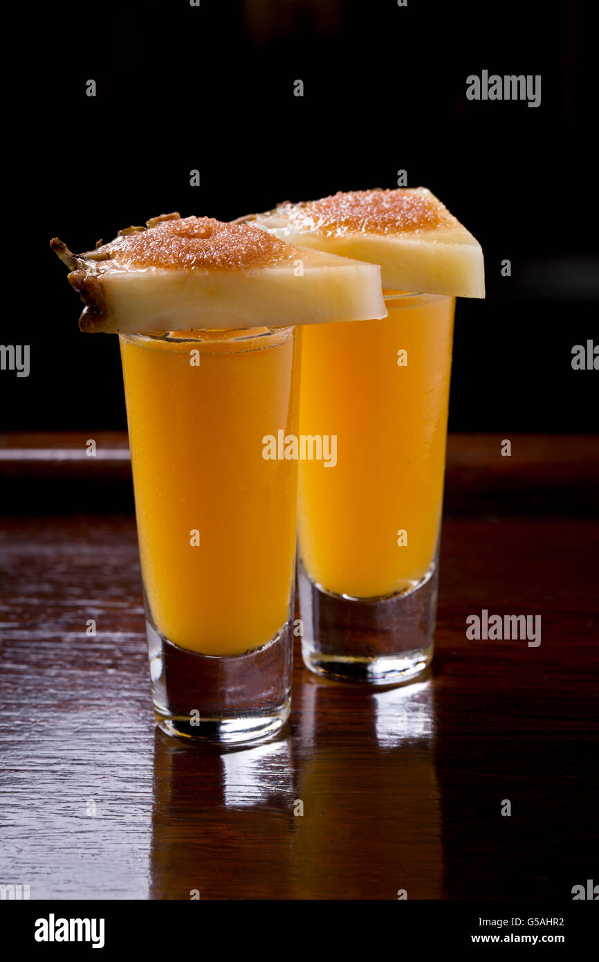 Tasty mango alcohol shots with pineapple and brown sugar Stock Photo ...